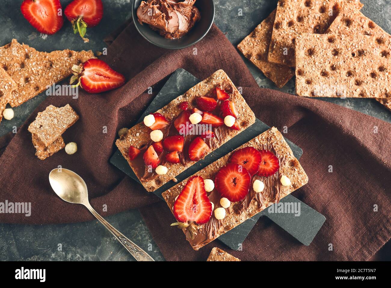Tasty crispbreads with chocolate and strawberry on dark background ...