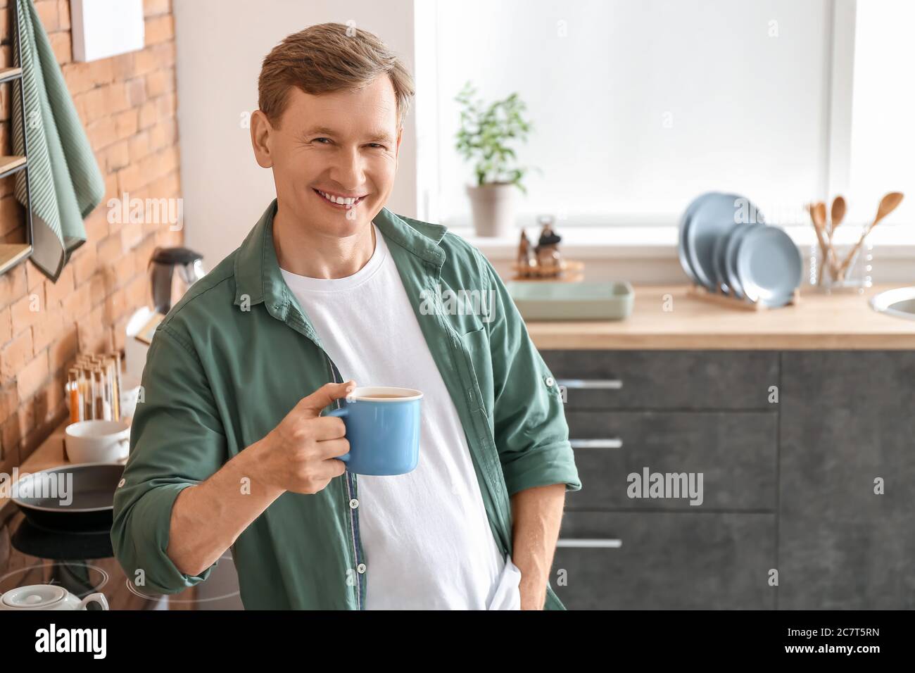 Handsome man drinking tea hi-res stock photography and images - Alamy