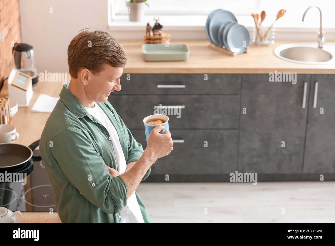 Handsome man drinking tea hi-res stock photography and images - Alamy