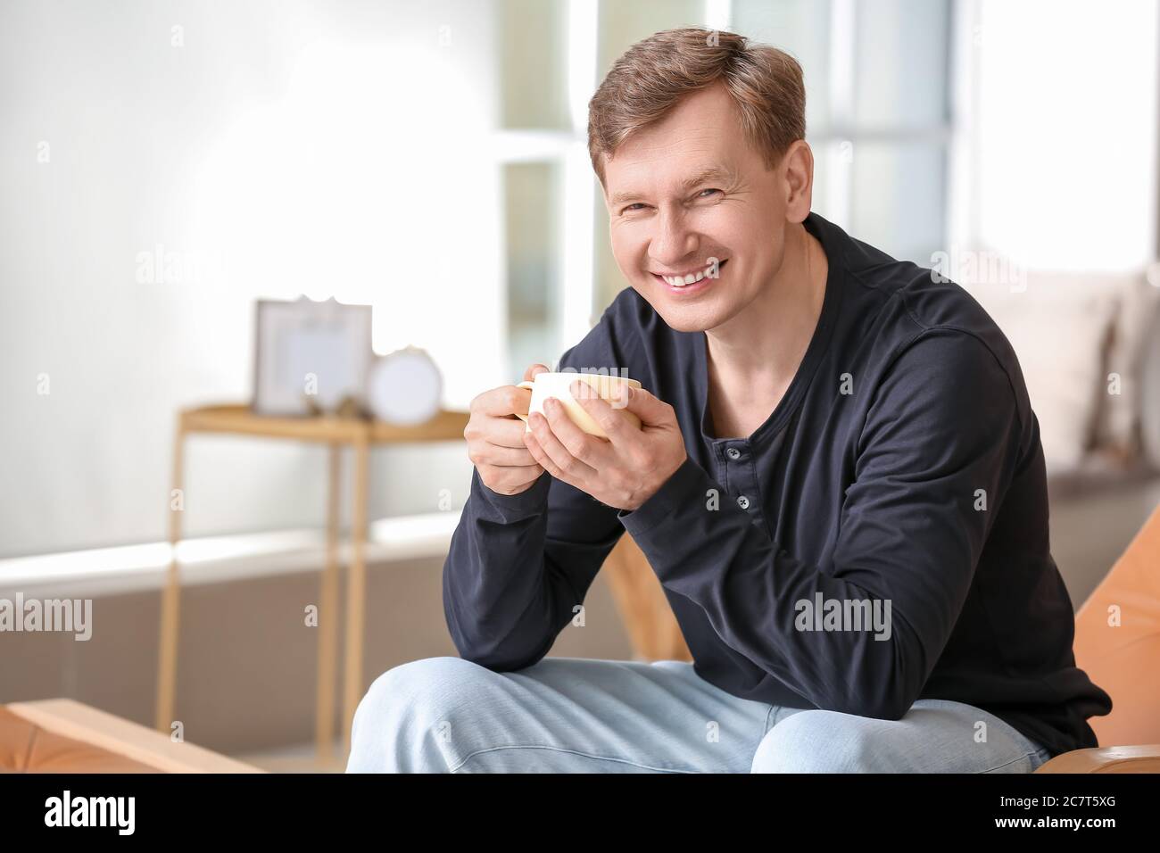 Handsome man drinking tea hi-res stock photography and images - Alamy