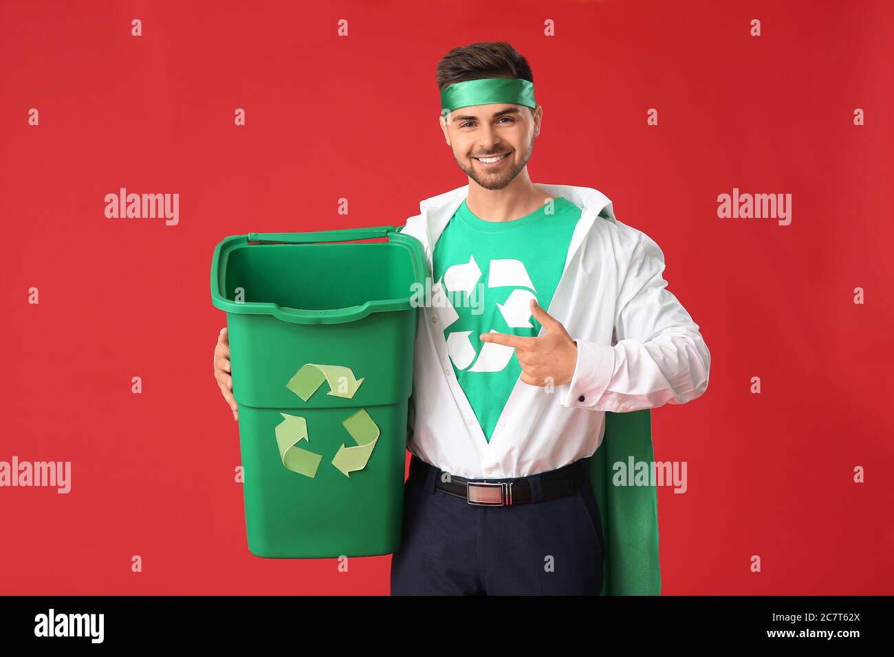 Man dressed as eco superhero with trash bin on color background Stock ...
