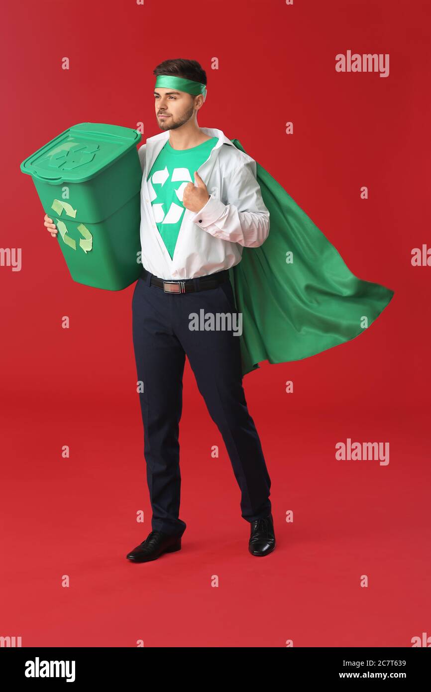 Man dressed as eco superhero with trash bin on color background Stock ...