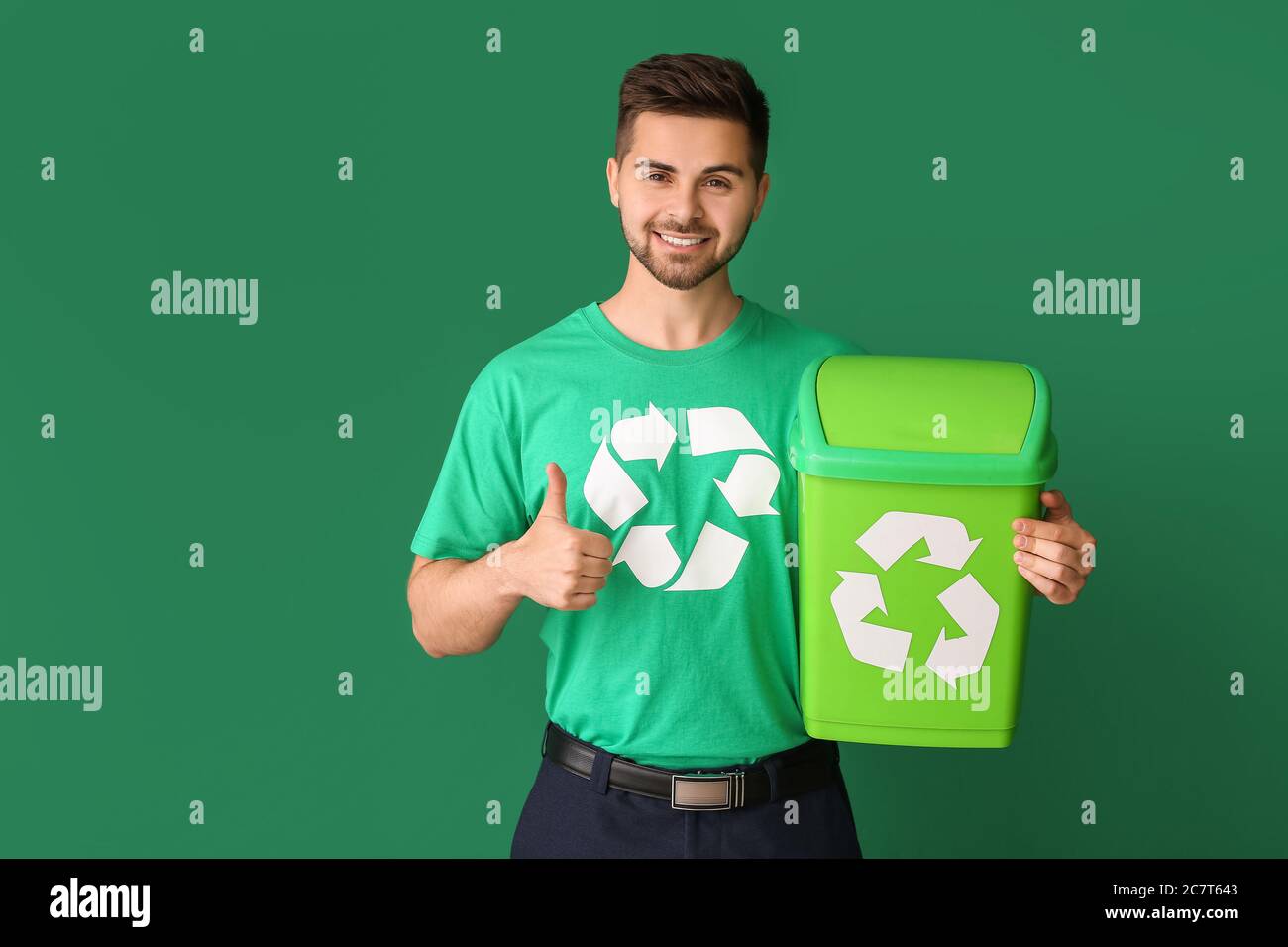Man in t-shirt with recycling sign and trash bin showing thumb-up ...