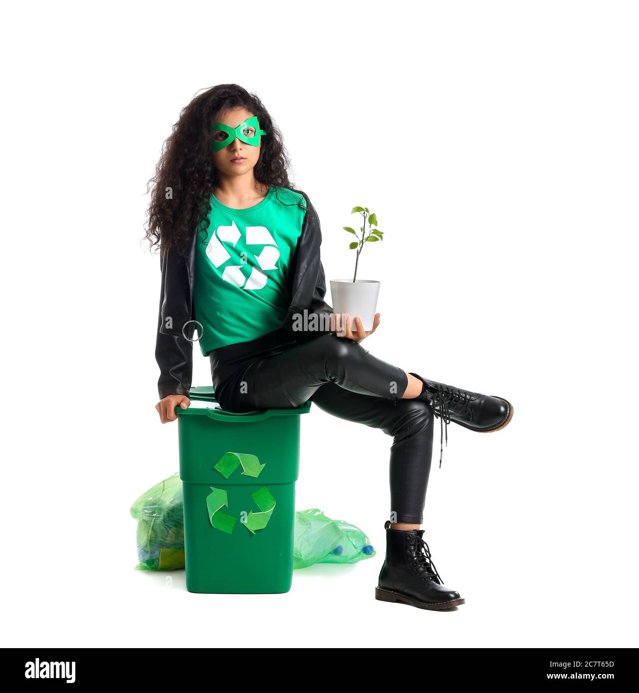 Woman dressed as eco superhero with trash bin and plant on white ...
