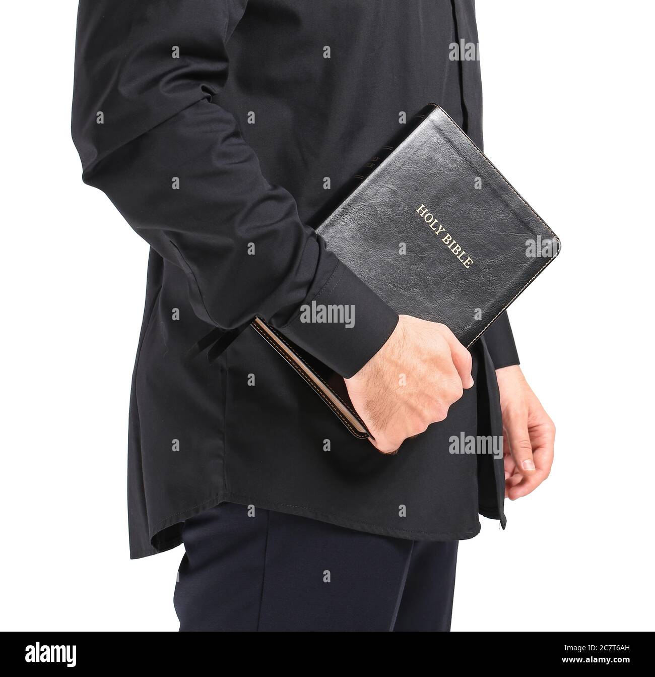 Handsome young priest with Bible on white background Stock Photo - Alamy
