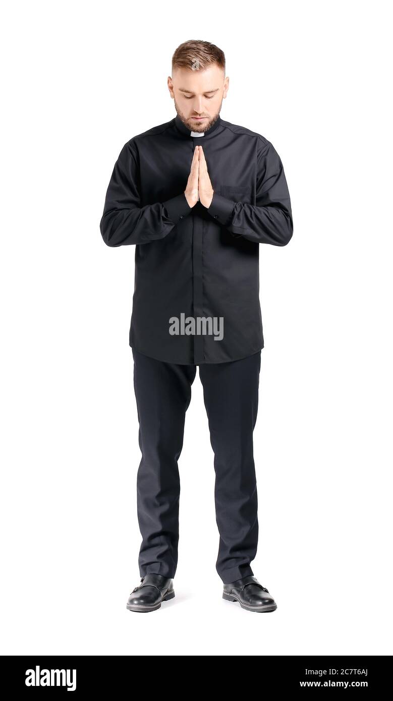 Young priest praying to God on white background Stock Photo - Alamy