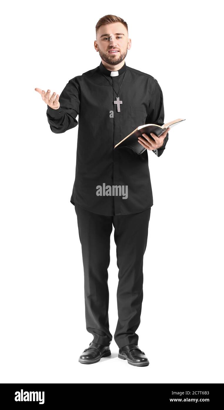 Handsome young priest with Bible on white background Stock Photo - Alamy