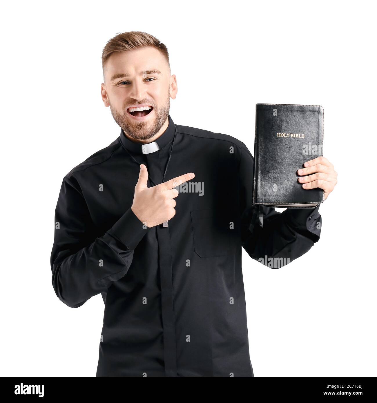 Handsome young priest with Bible on white background Stock Photo - Alamy