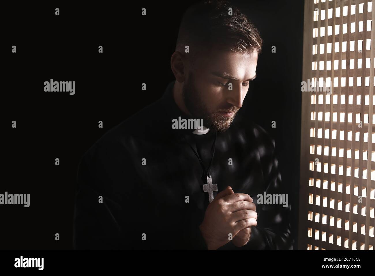 Priest in confession booth in hi-res stock photography and images - Alamy