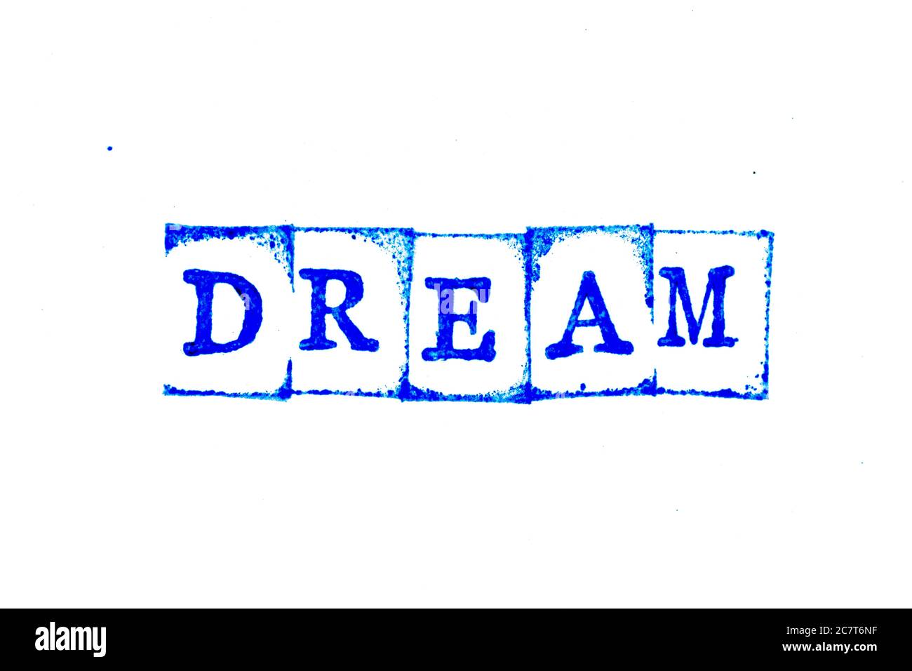 Blue color ink of rubber stamp in word dream on white paper background ...