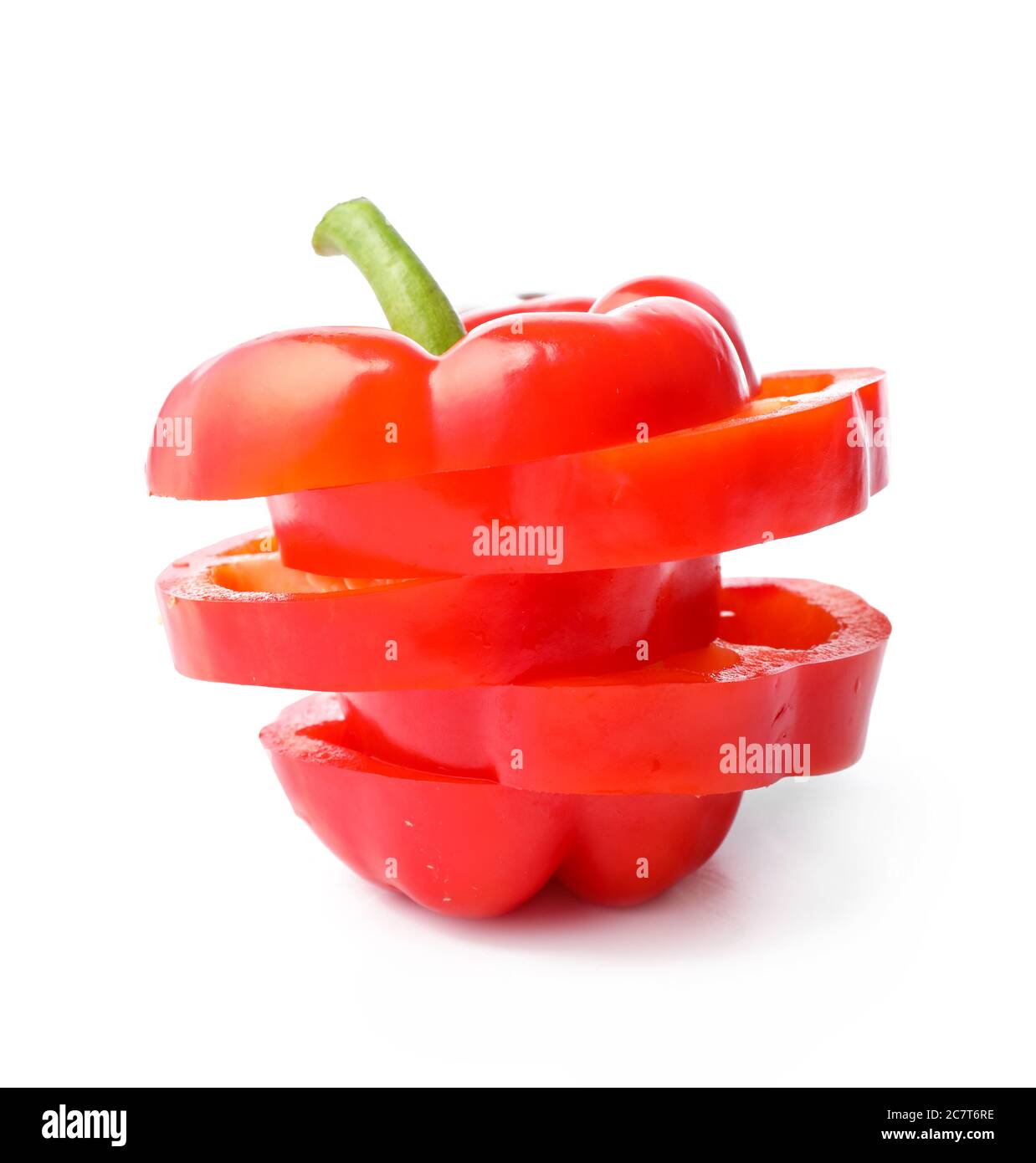 Cut red bell pepper on white background Stock Photo - Alamy