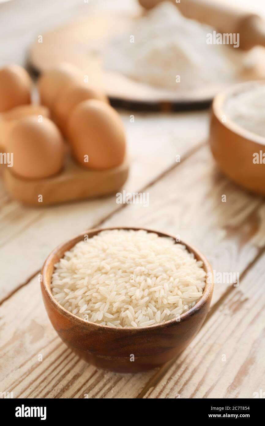 Bowl with raw rice on table Stock Photo - Alamy