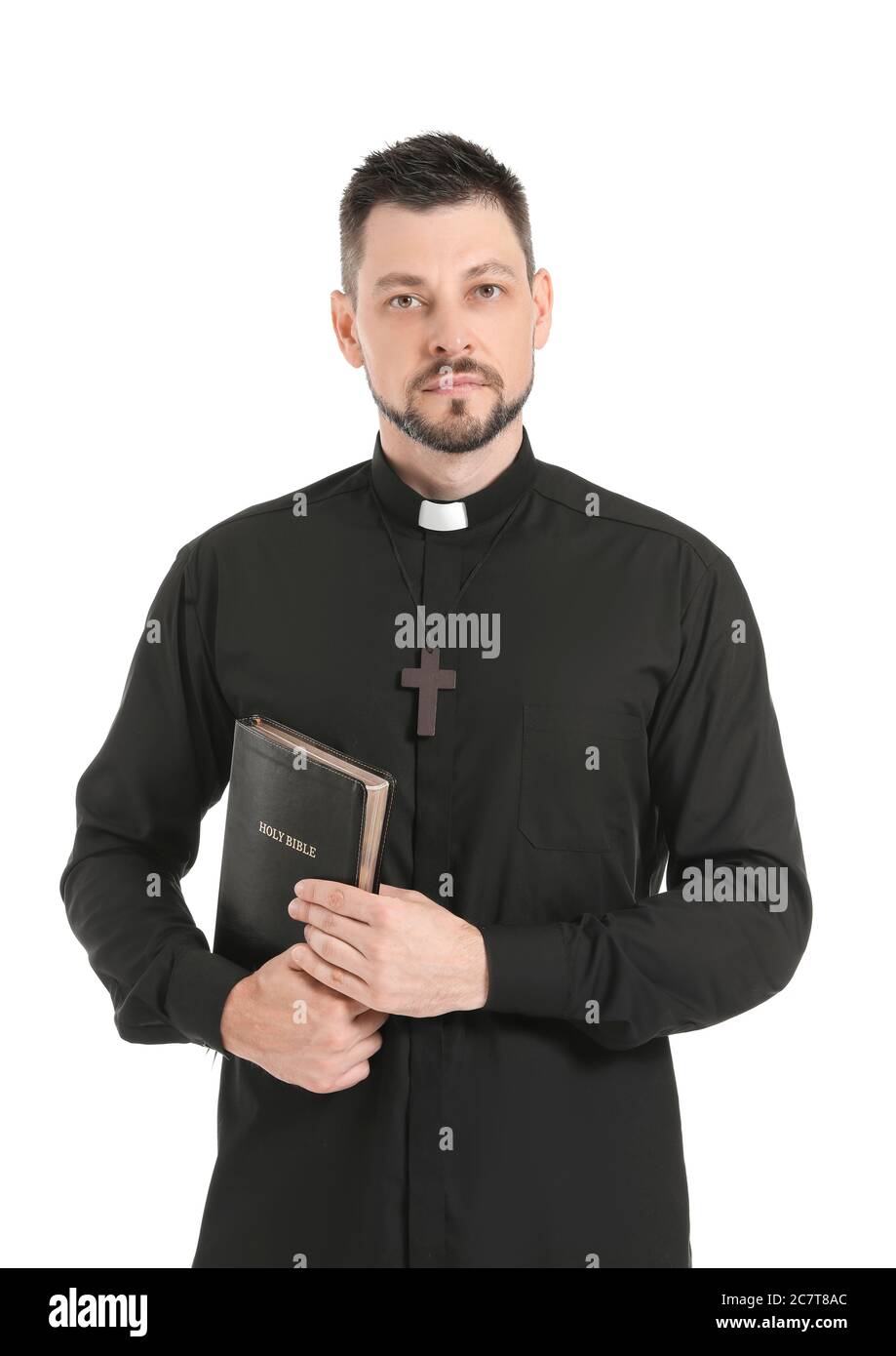 Handsome priest with Bible on white background Stock Photo - Alamy