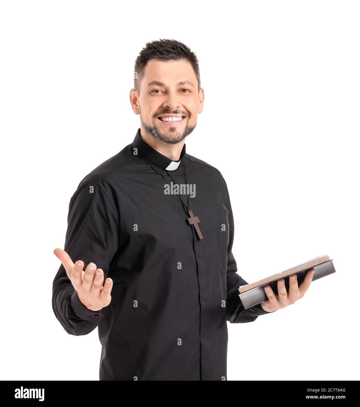 Handsome priest with Bible on white background Stock Photo - Alamy