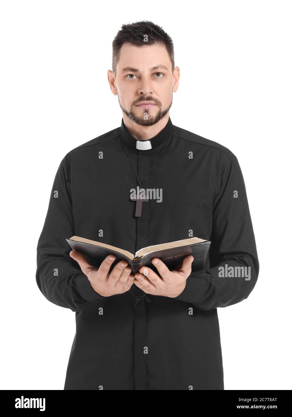 Handsome priest with Bible on white background Stock Photo - Alamy
