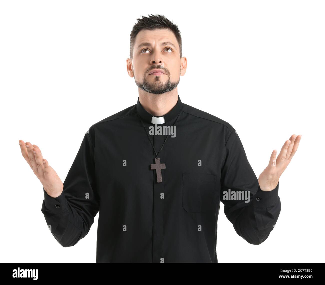 Handsome praying priest on white background Stock Photo - Alamy