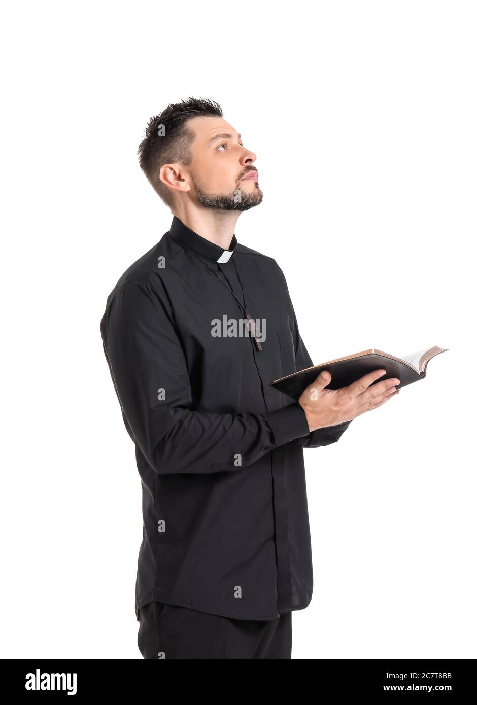 Handsome priest with Bible on white background Stock Photo - Alamy