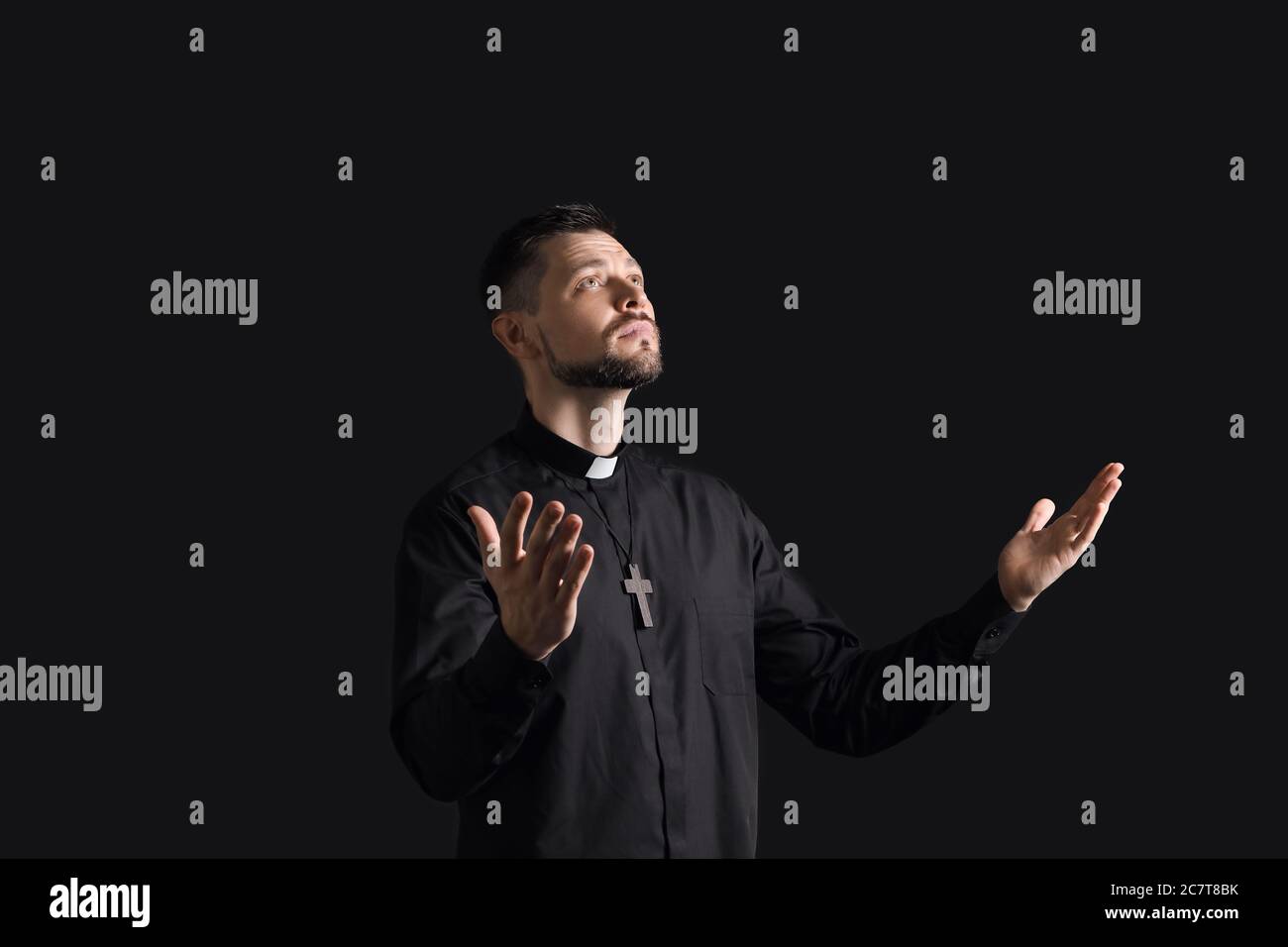 Handsome praying priest on hi-res stock photography and images - Alamy
