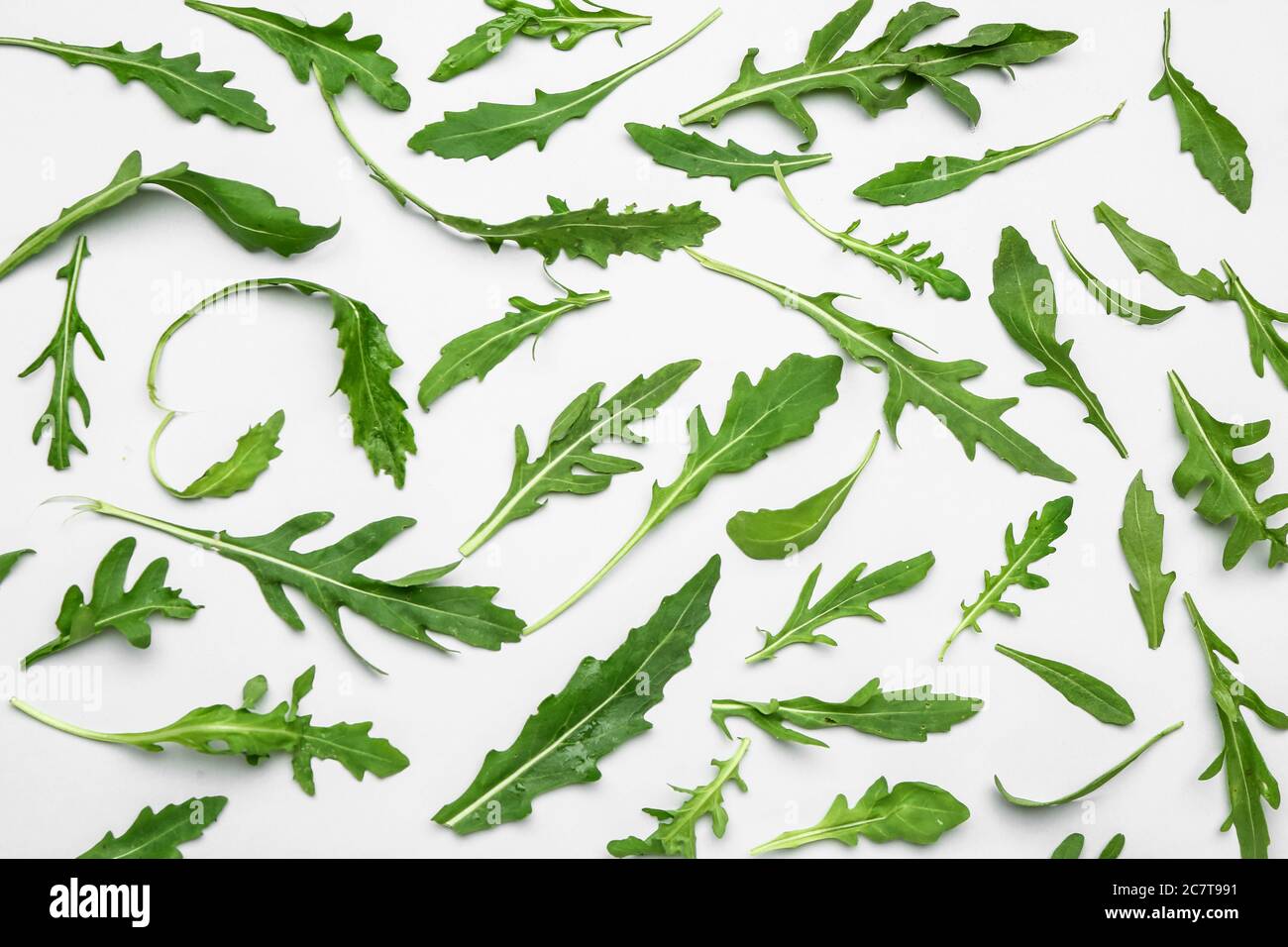 Fresh arugula on white background Stock Photo - Alamy