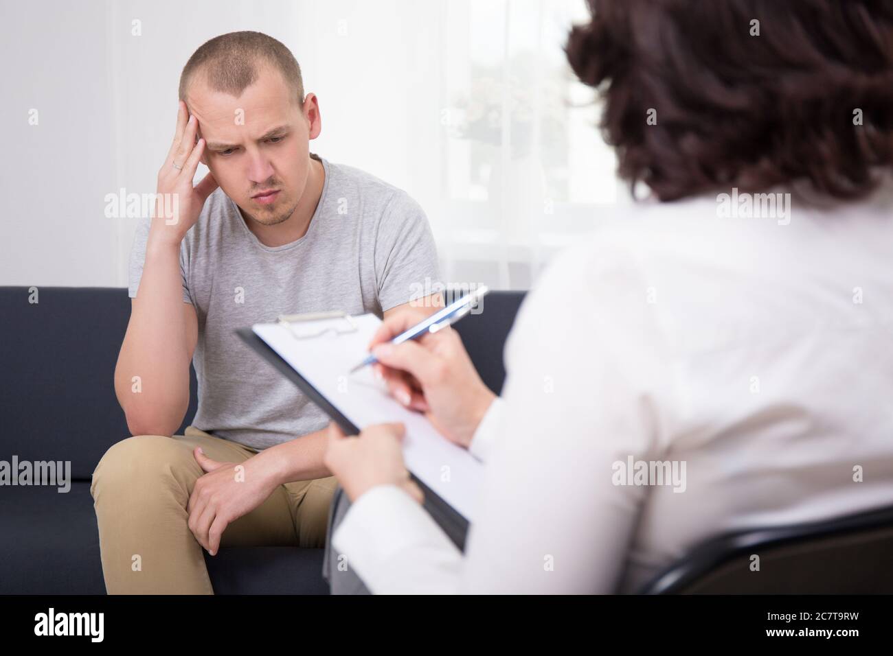 sad man listening to employer on interview in office Stock Photo - Alamy