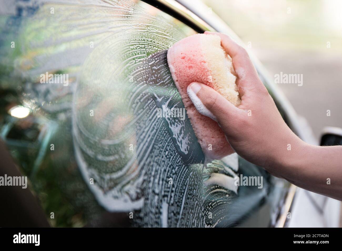 handle car wash concept - close up of male hand holding sponge and ...