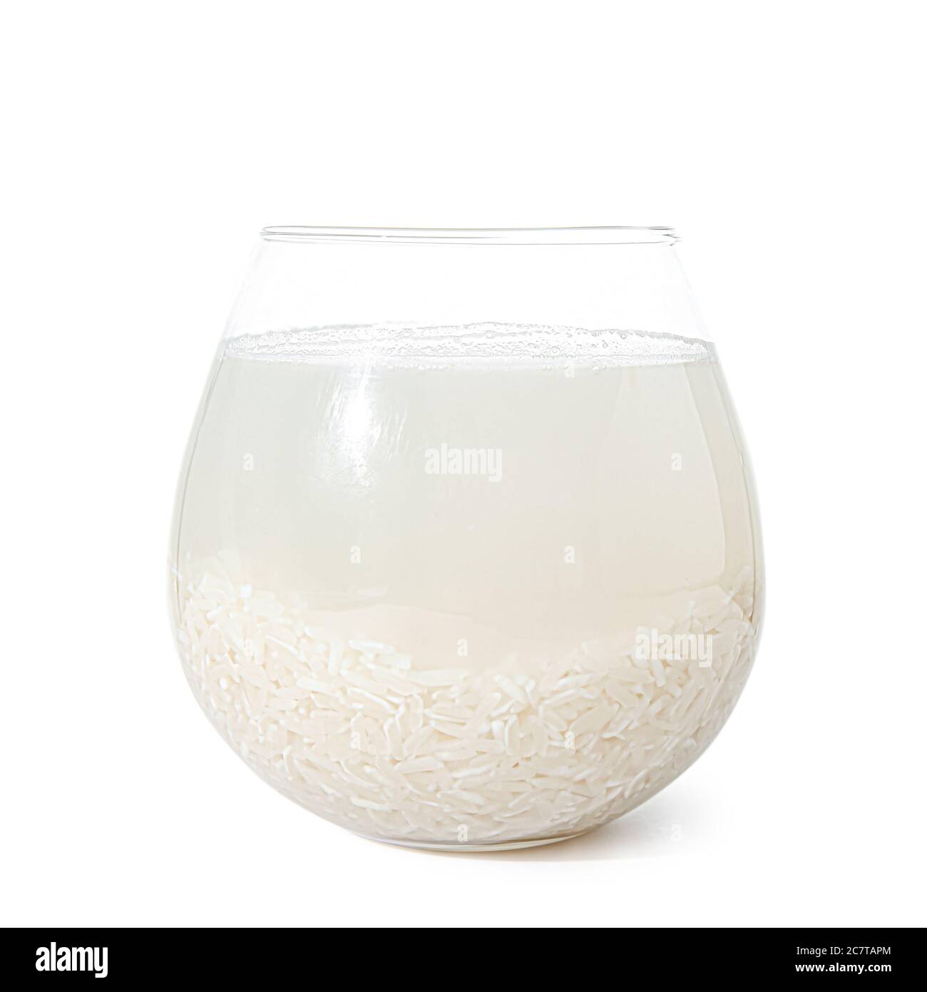 Glass of rice water on white background Stock Photo - Alamy