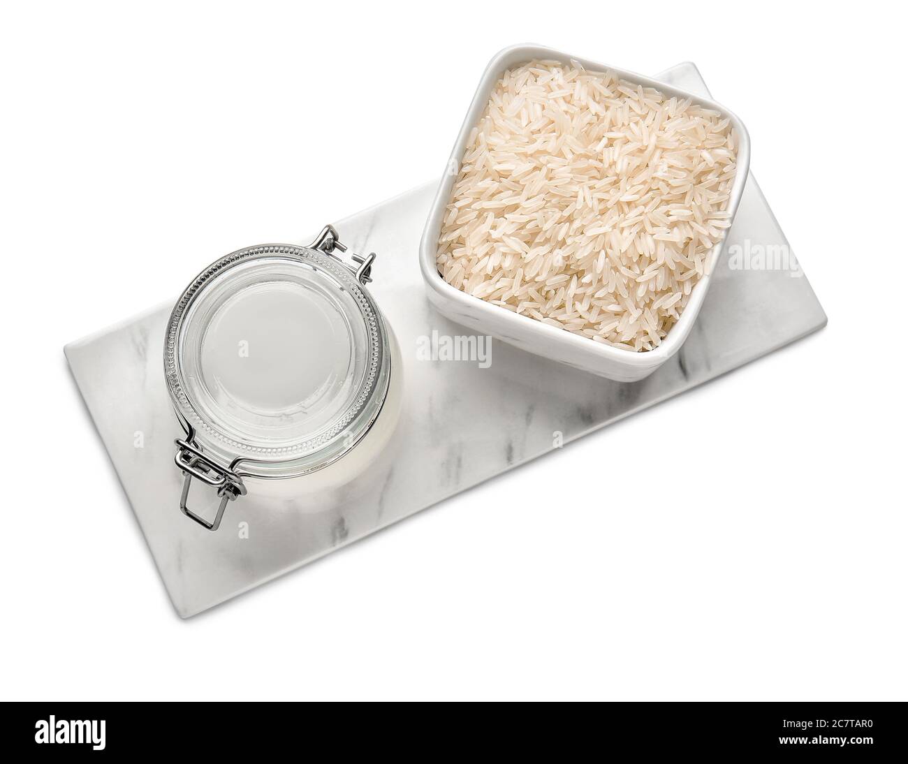 Jar of rice water on white background Stock Photo - Alamy