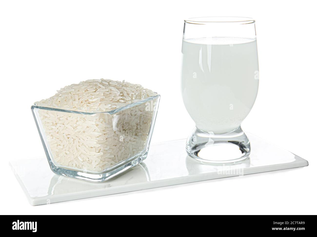 Glass of rice water on white background Stock Photo - Alamy