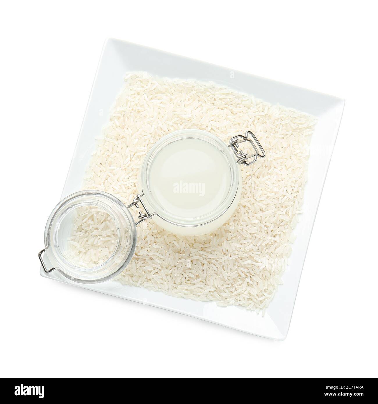 Jar of rice water on white background Stock Photo - Alamy