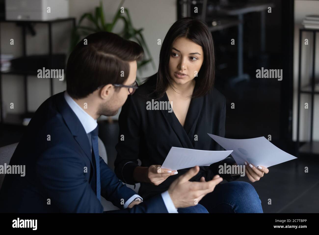 Multiracial businesspeople cooperate discuss paperwork in office Stock ...