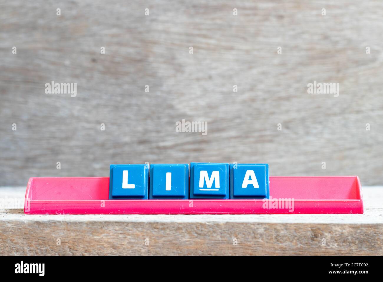 Tile letter on red rack in word Lima on wood background Stock Photo - Alamy