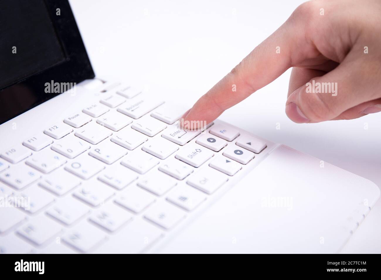 female hand pushing enter button on white laptop keyboard Stock Photo ...