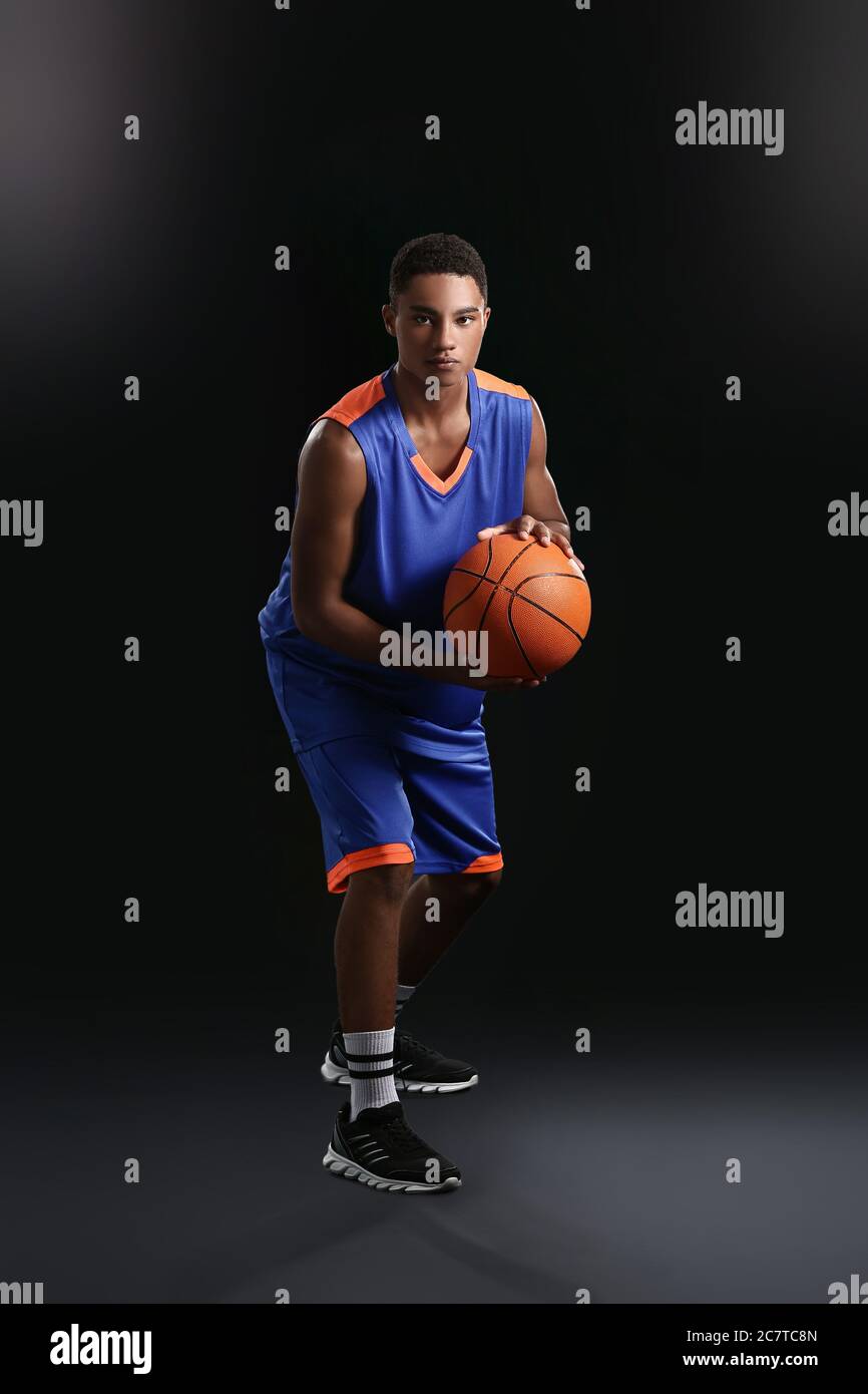 Young African-American basketball player on dark background Stock Photo ...