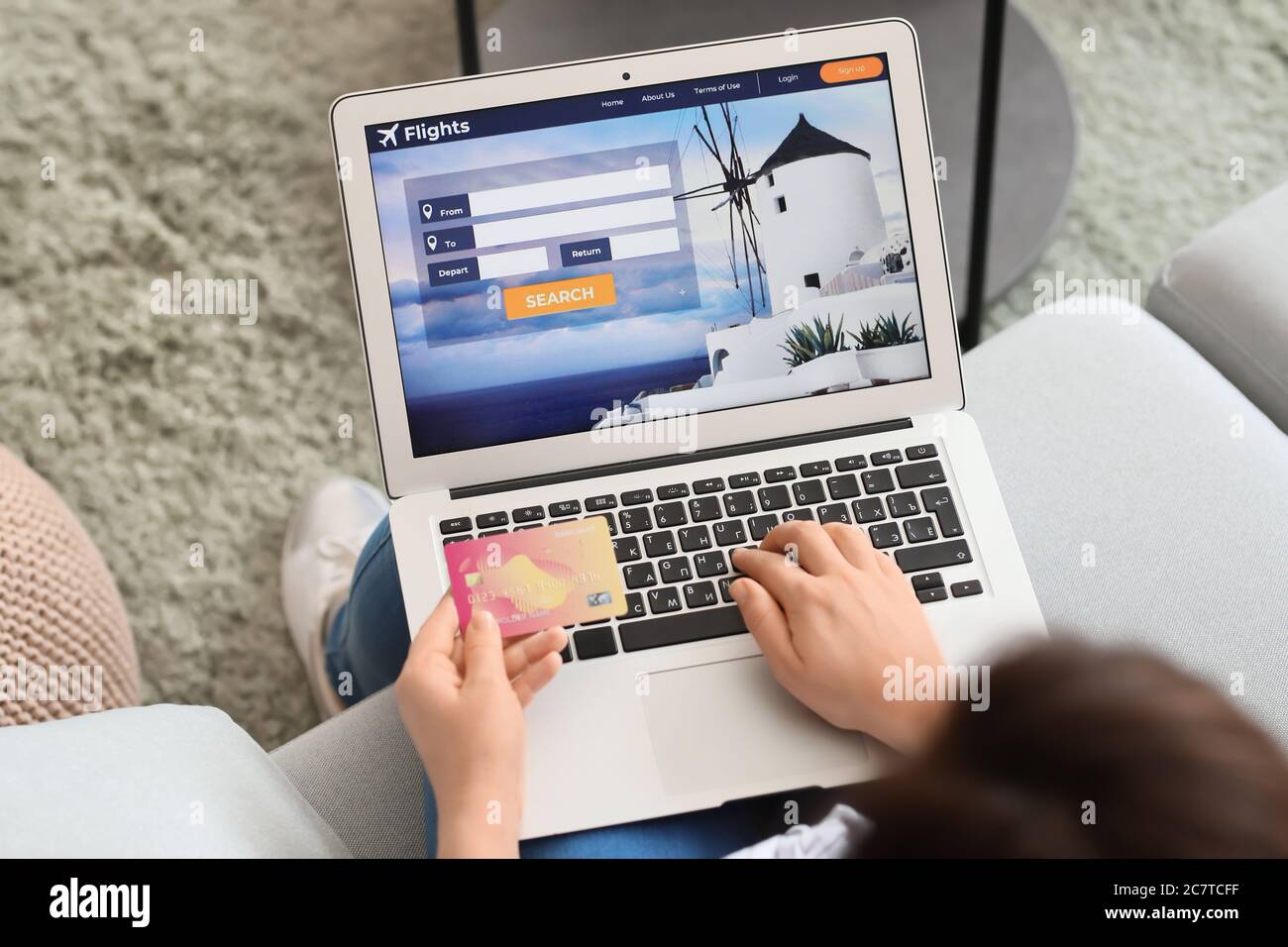 Woman with laptop booking tickets online at home Stock Photo - Alamy