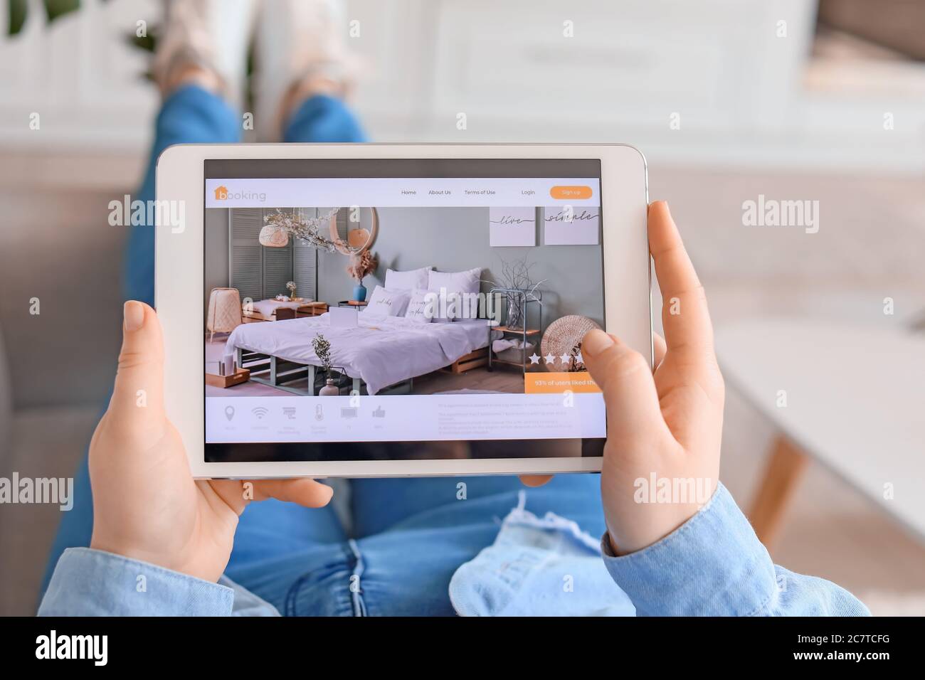 Woman with tablet computer booking room in hotel at home Stock Photo ...