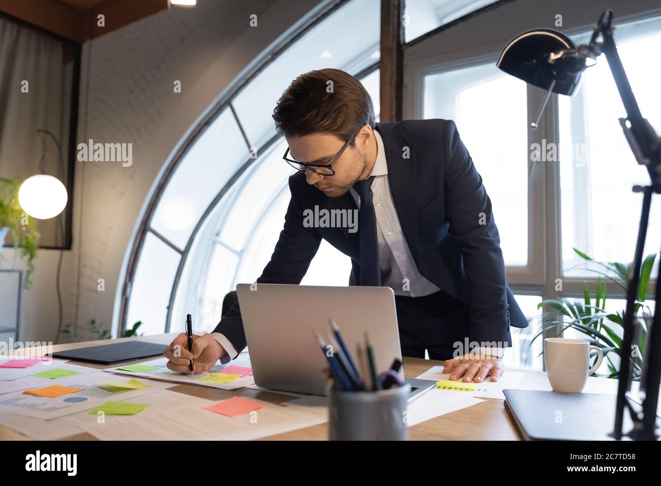 Focused young businessman work with documents in office Stock Photo - Alamy