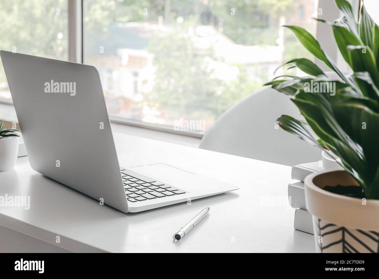 Modern laptop on table in room Stock Photo - Alamy