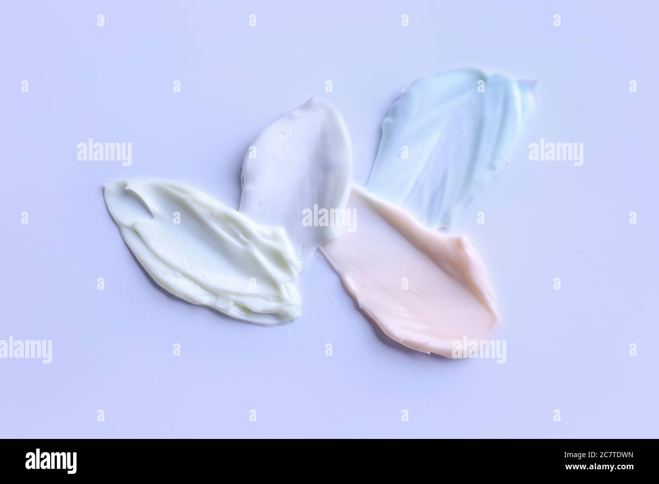 Samples of cream on color background Stock Photo - Alamy