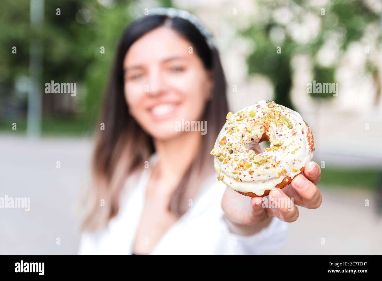 Donut in hand hi-res stock photography and images - Alamy