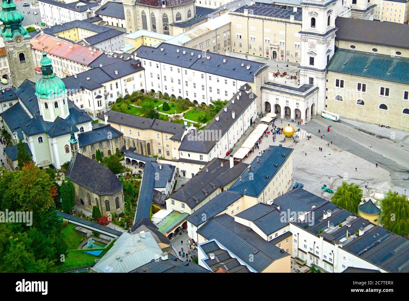 High angle shot of a small town with white buildings and a plaza in the ...