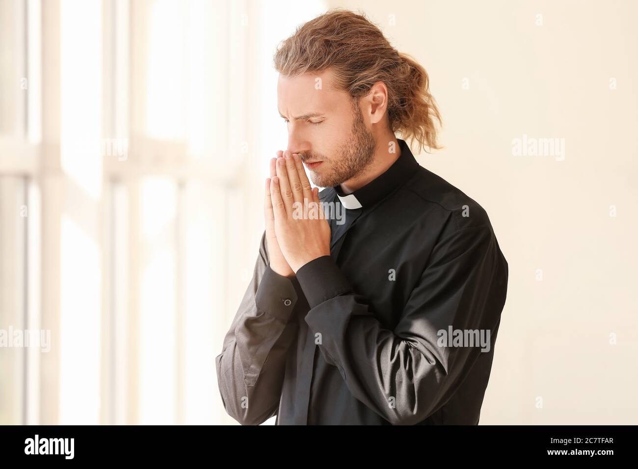 Male priest praying at home Stock Photo - Alamy