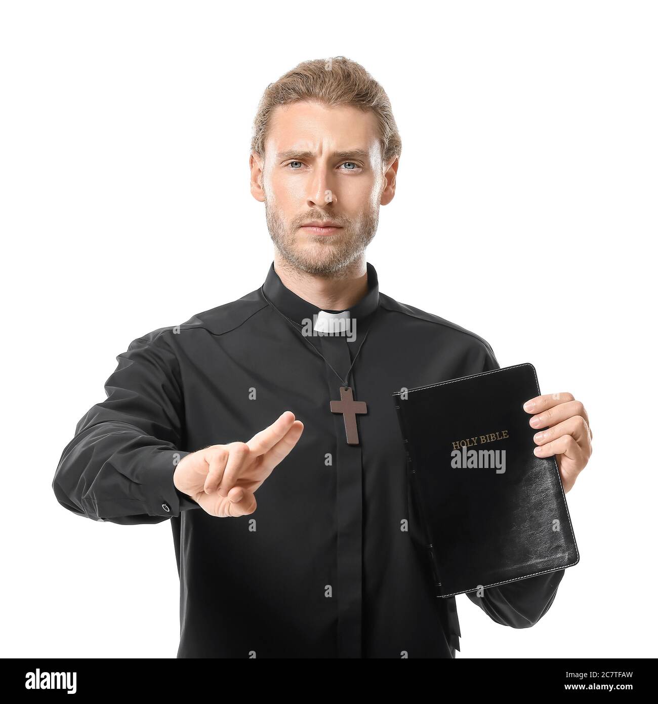 Handsome priest with Bible on white background Stock Photo - Alamy