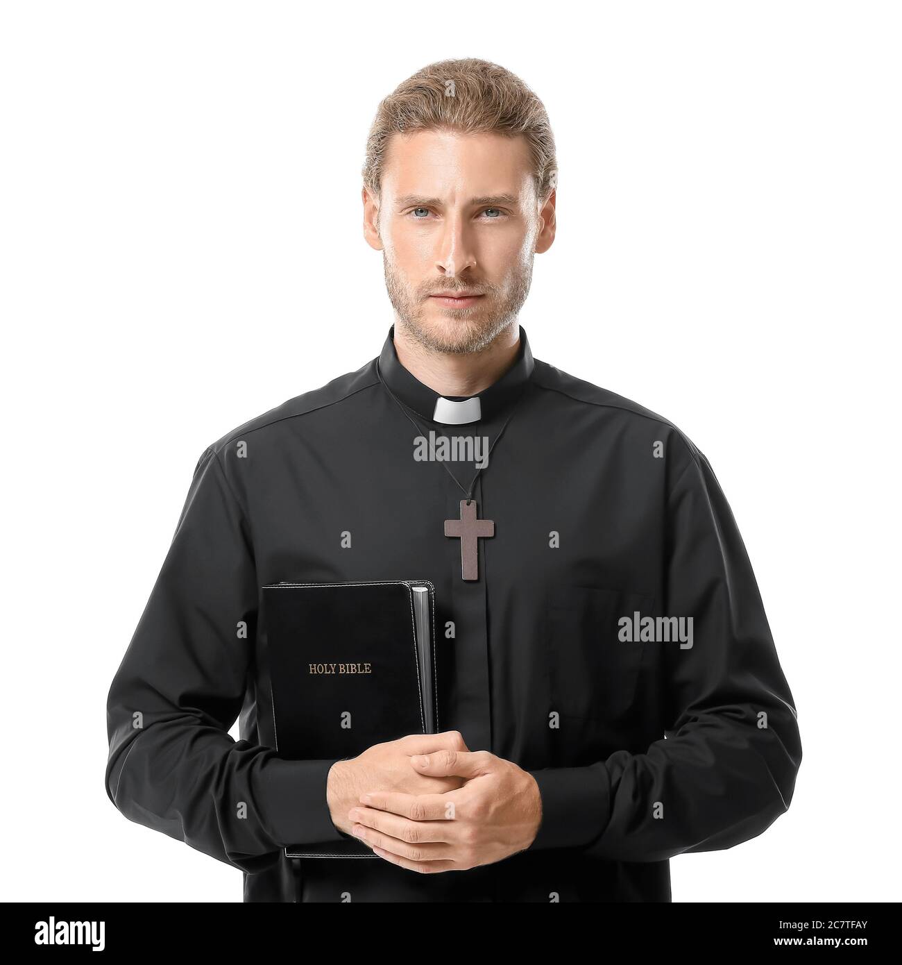 Handsome priest with Bible on white background Stock Photo - Alamy