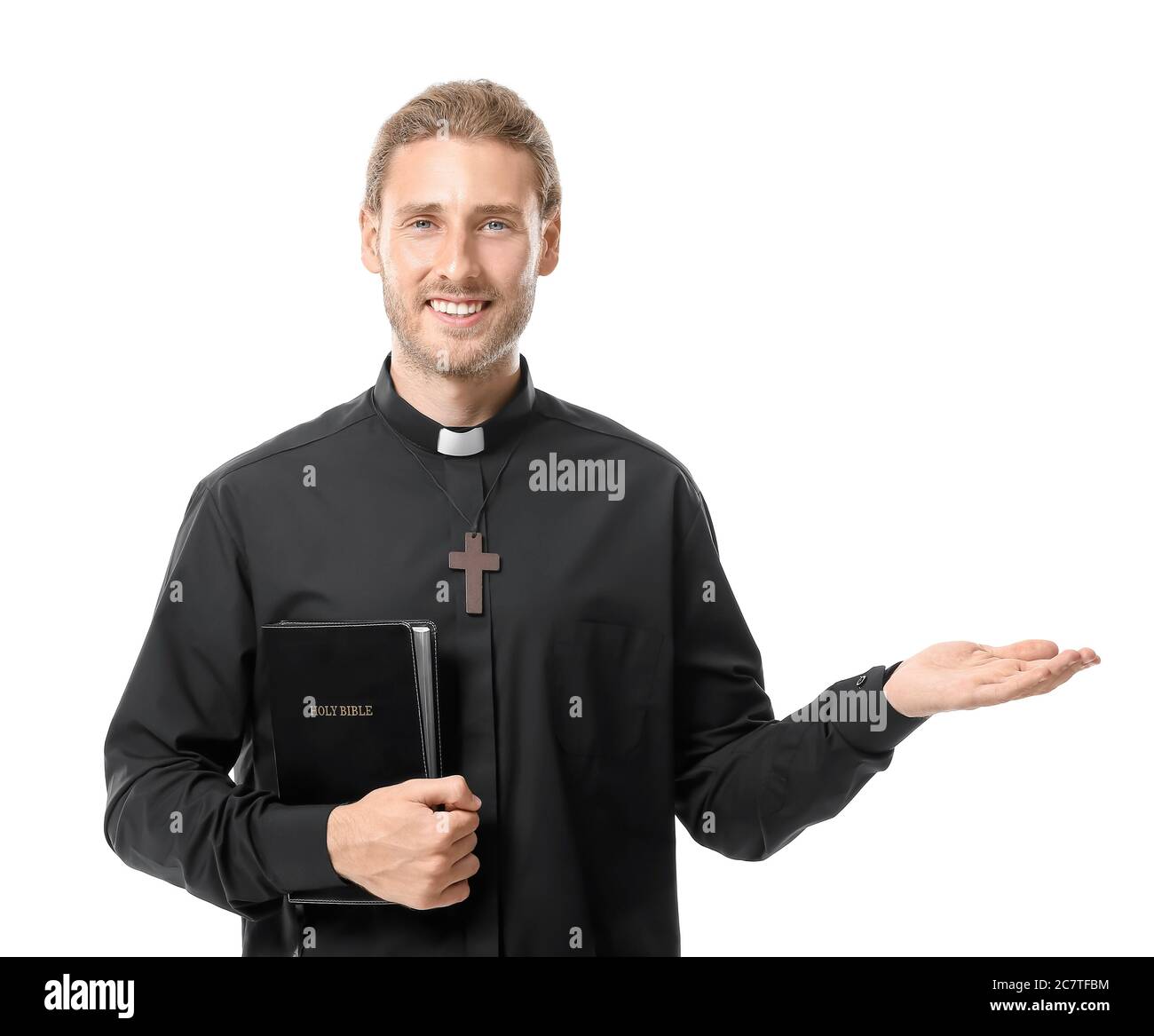 Handsome priest with Bible on white background Stock Photo - Alamy