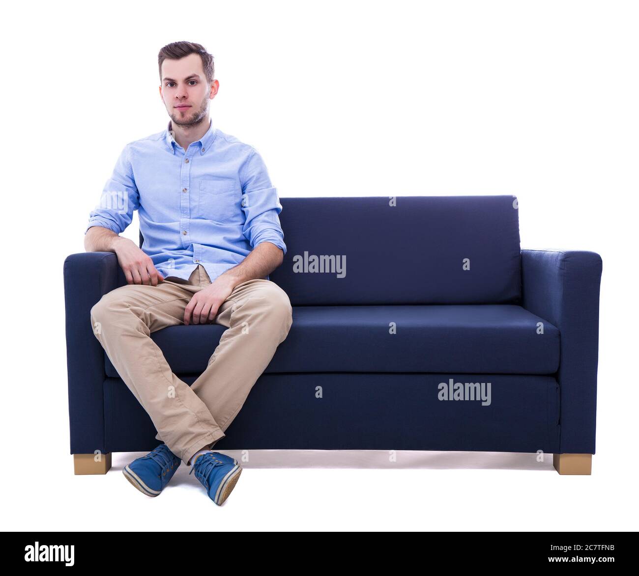 handsome man sitting on sofa isolated on white background Stock Photo ...