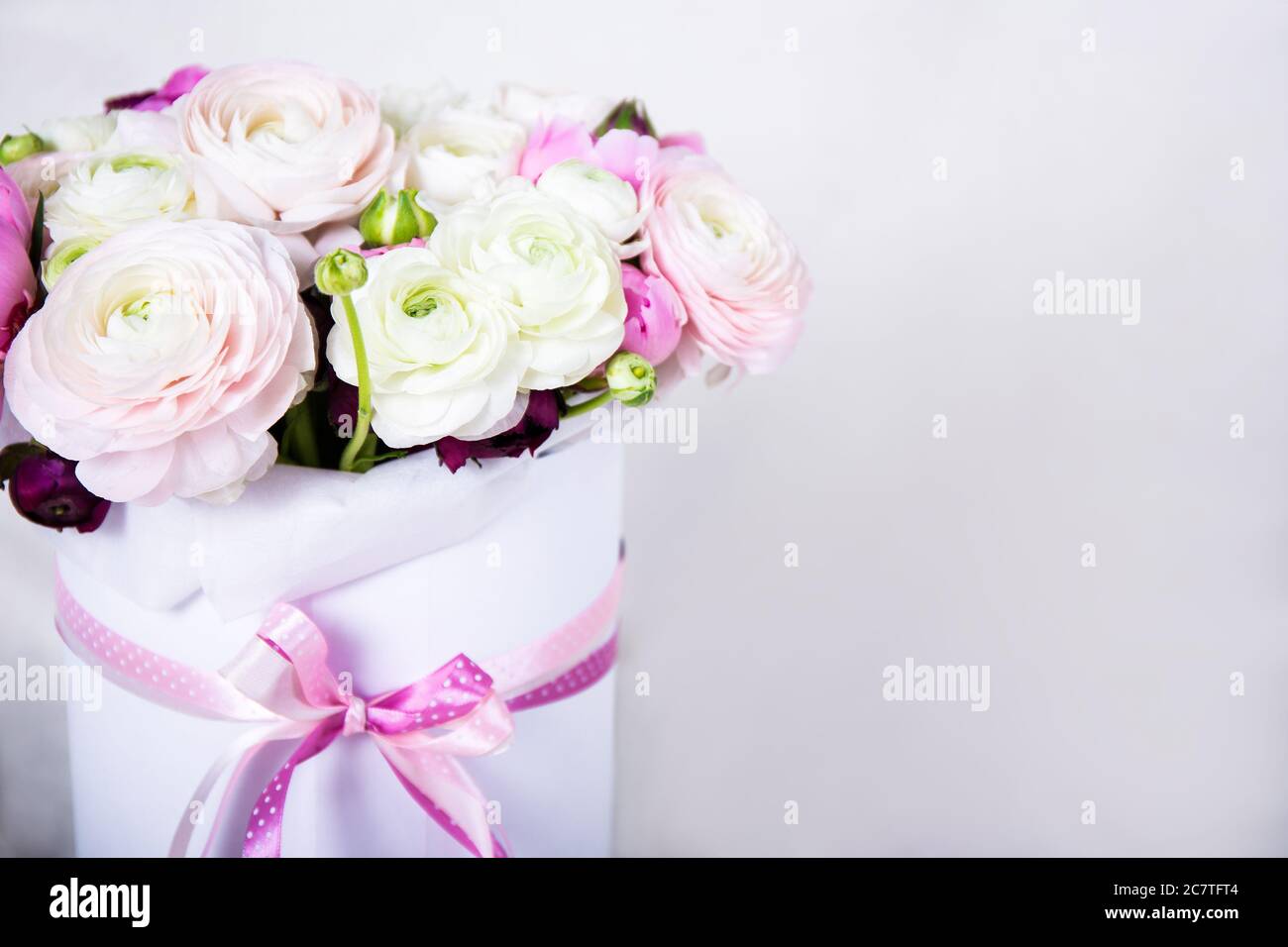 big beautiful bunch of summer flowers in round cardboard box over white ...