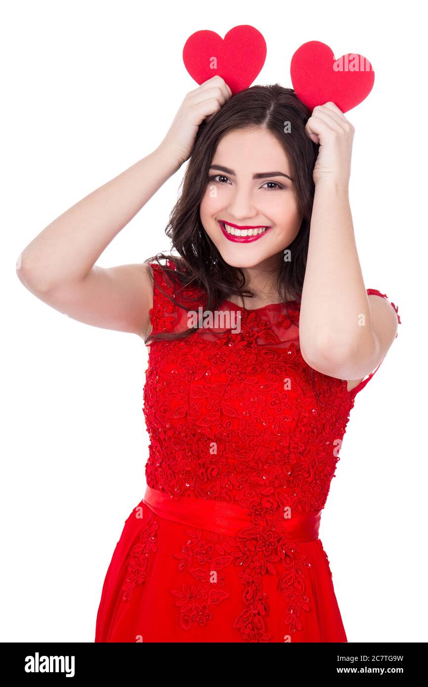portrait of cute funny woman in red dress holding two paper hearts ...