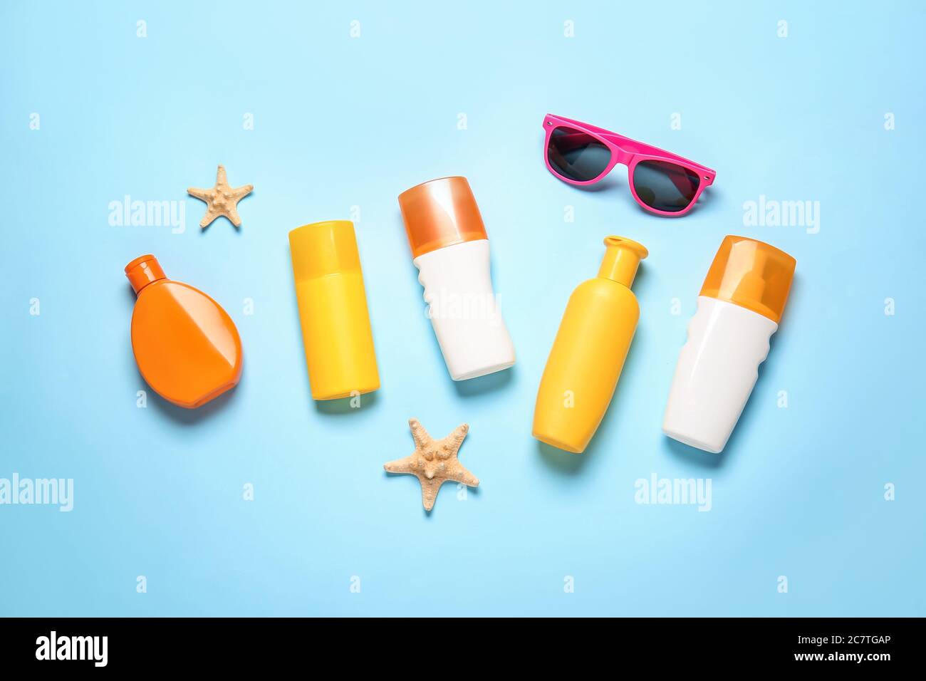 Bottles of sunscreen with sunglasses on color background Stock Photo ...