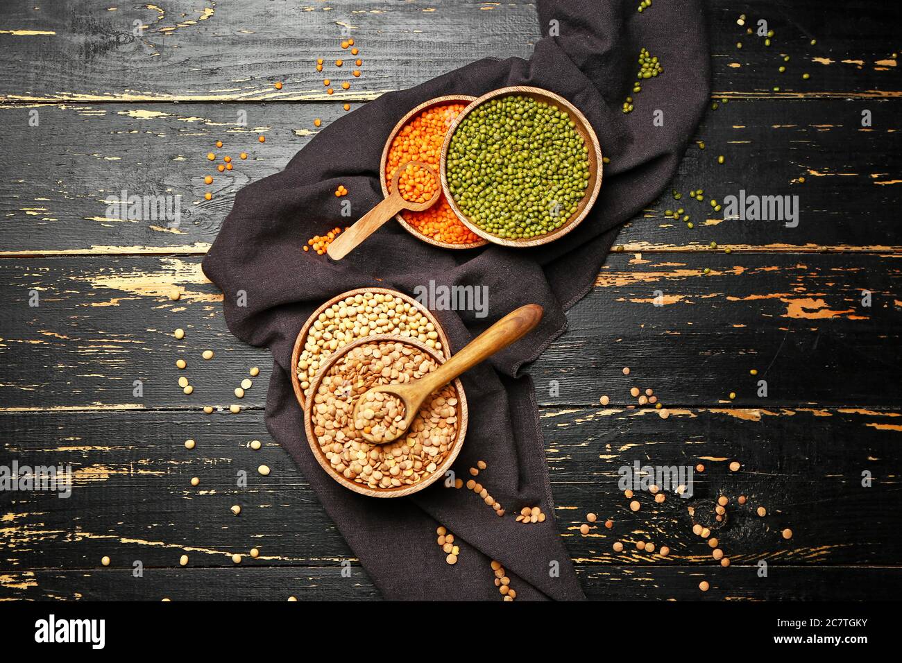 Different raw legumes on dark wooden background Stock Photo - Alamy