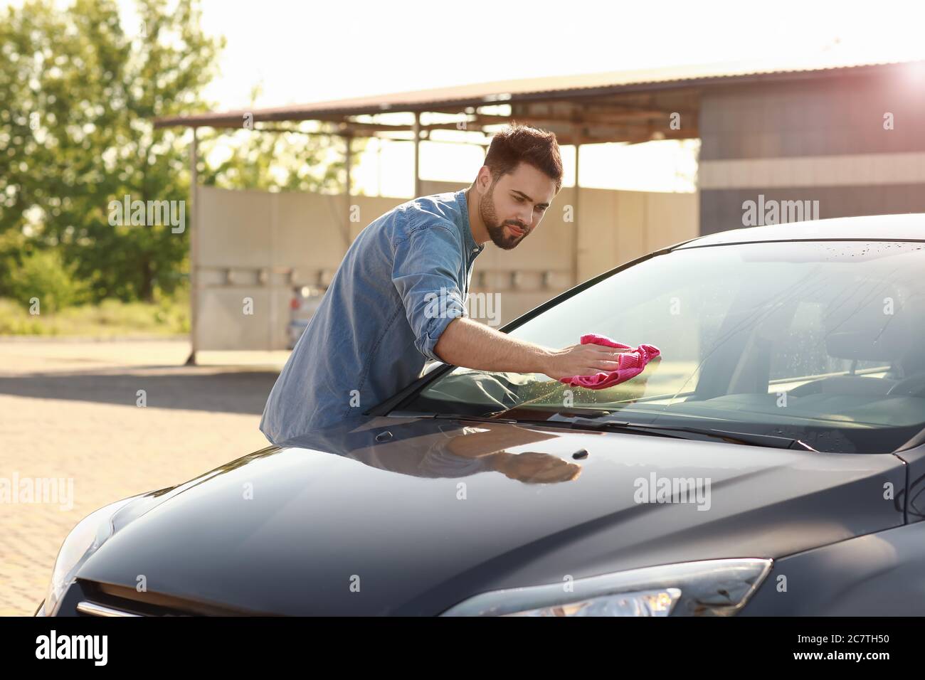 Man washing his car outdoors Stock Photo - Alamy